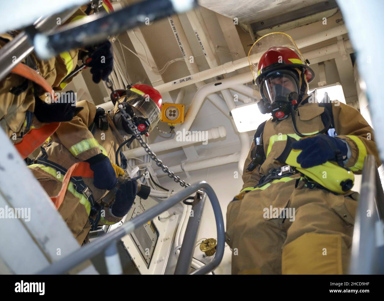 PHILIPPINE SEA (Dec. 20, 2021) Sailors move down a ladderwell aboard ...