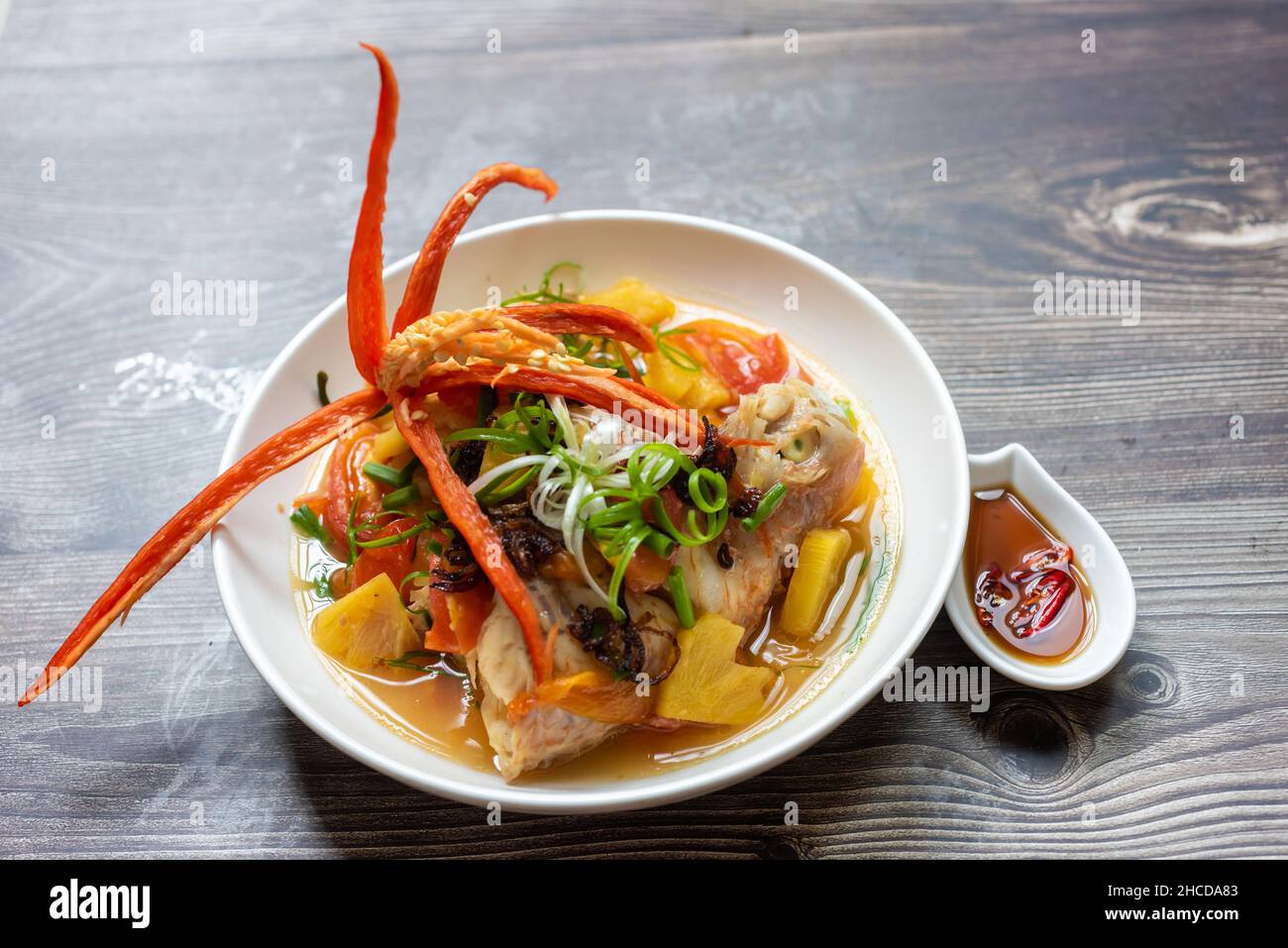 Steamed red snapper fish with ingredients including fish, pineapple ...