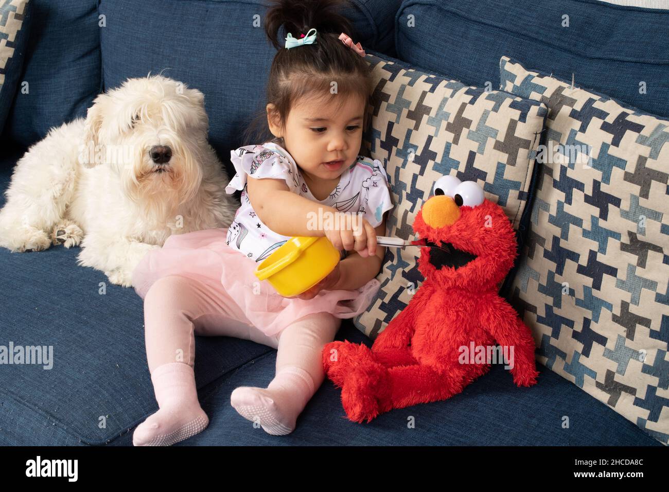 17 month old toddler girl pretend play feeding toy Elmo doll with fork ...