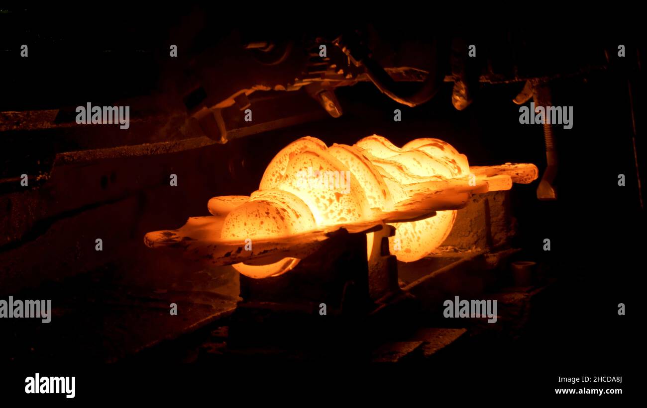 Steel quenching at high temperature in industrial furnace at the ...