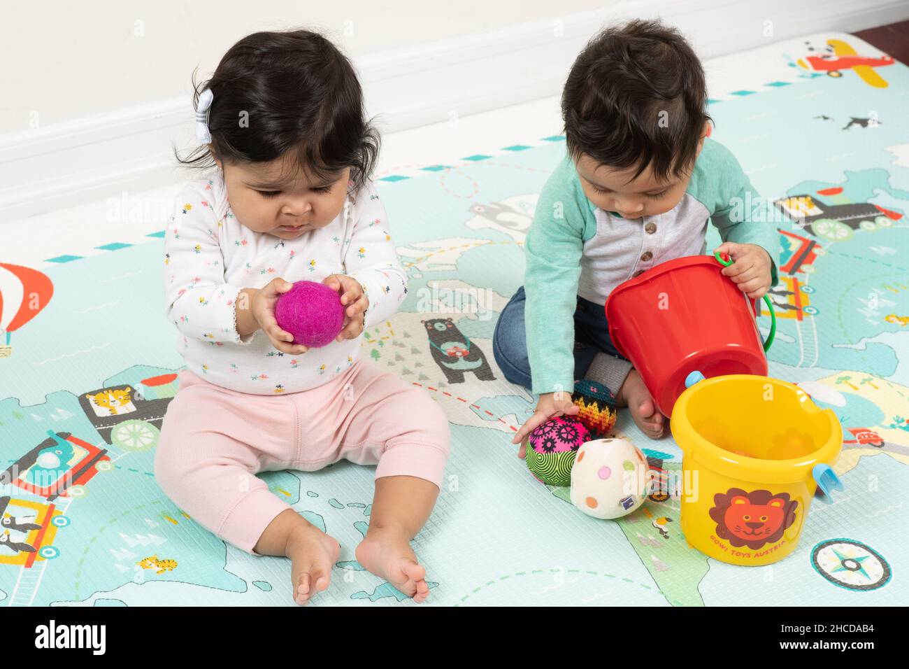 8 month old fraternal twin babies boy and girl sitting side by side ...