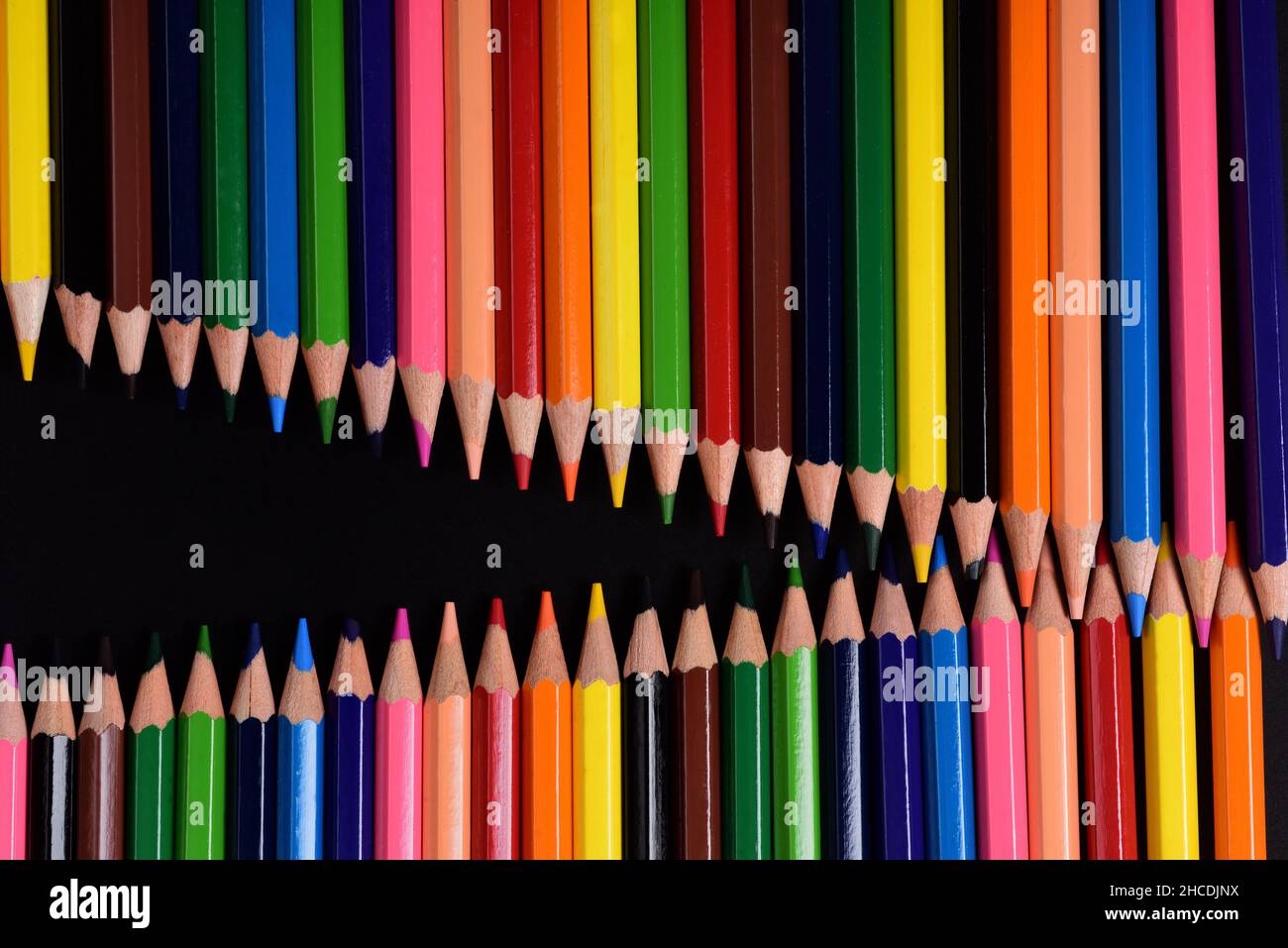 Close up of lots of wooden crayons of different colors facing each ...