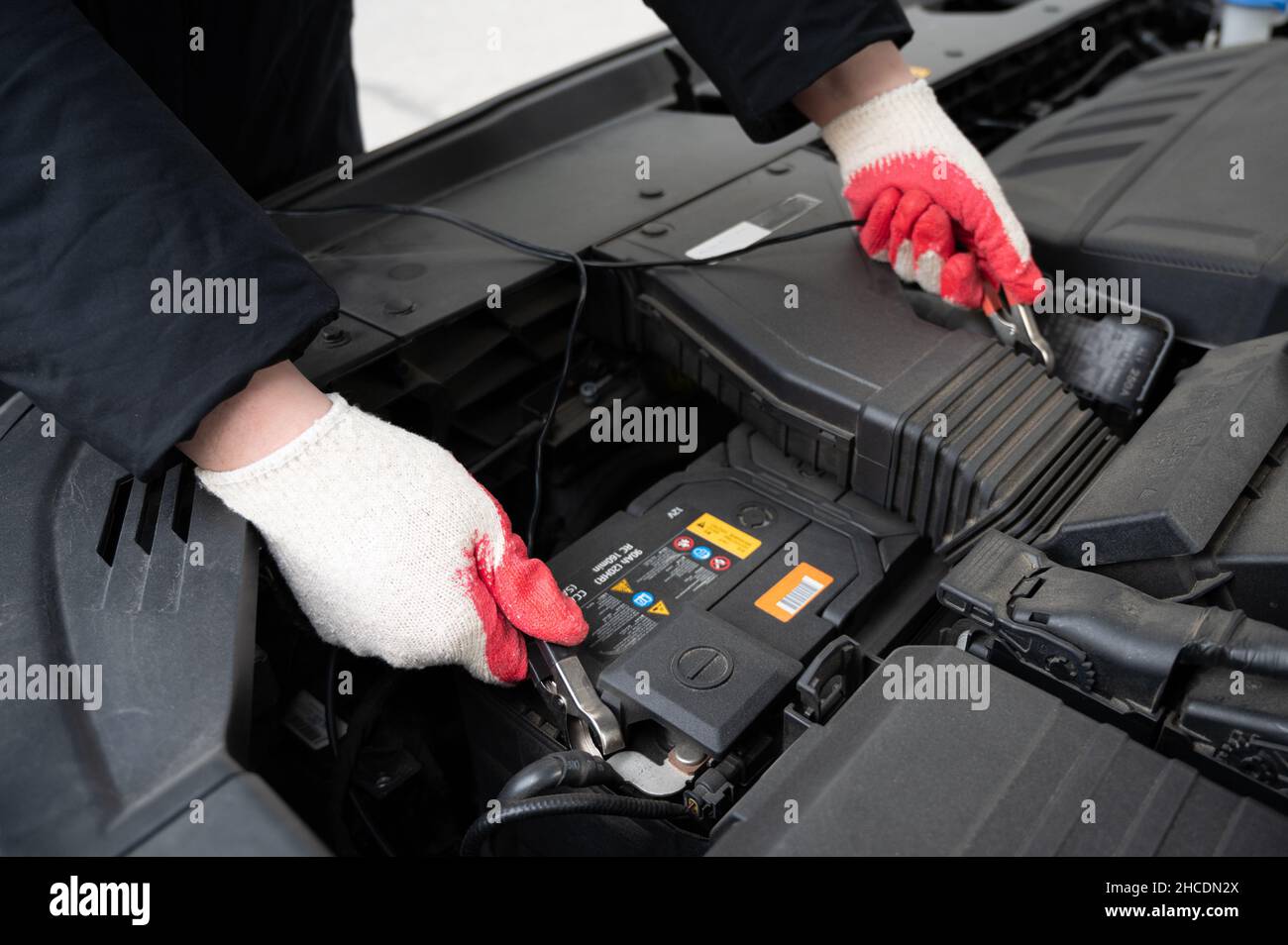 Driver's hand checking the condition of the car's battery Stock Photo ...