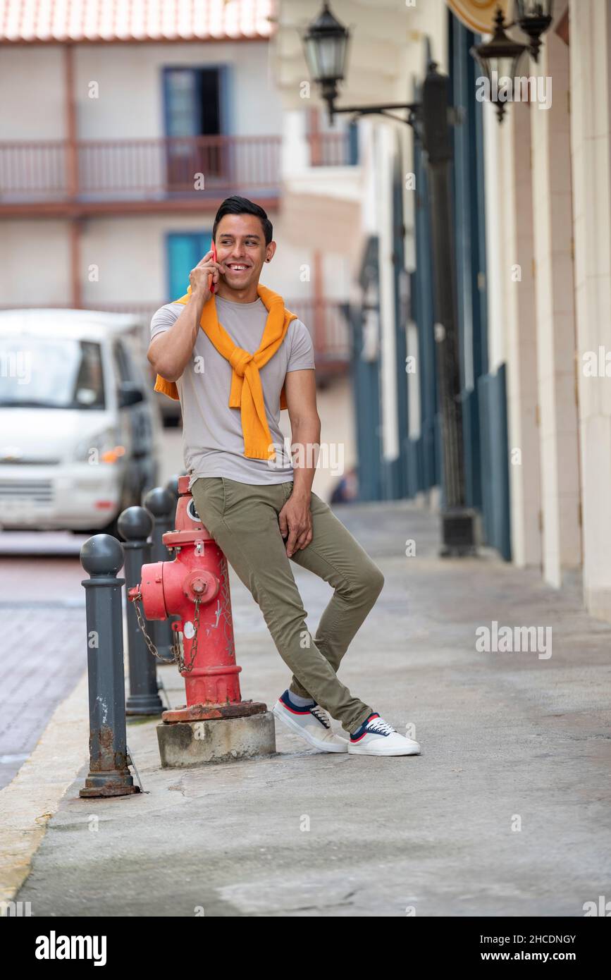 Young latino man in the city talking by mobile phone, Panama City ...