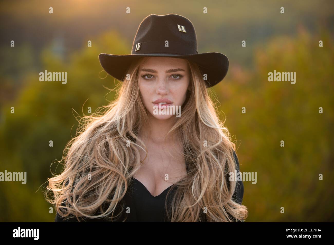 Portrait of beautiful young woman in summer vogue hat. Outdoor portrait ...