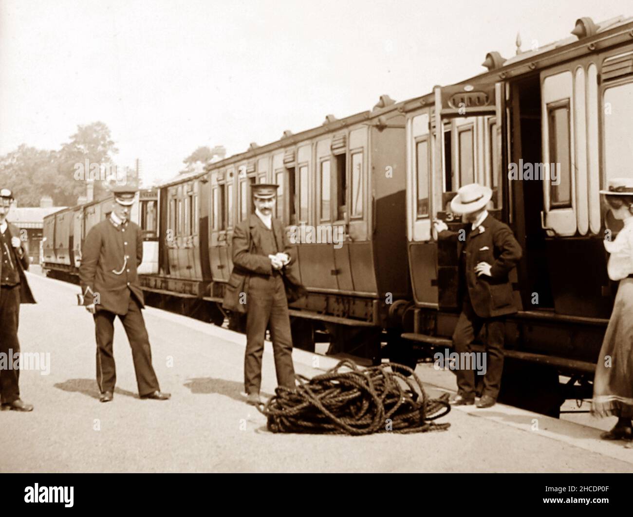 Passengers and porters at an English railway station considering what ...