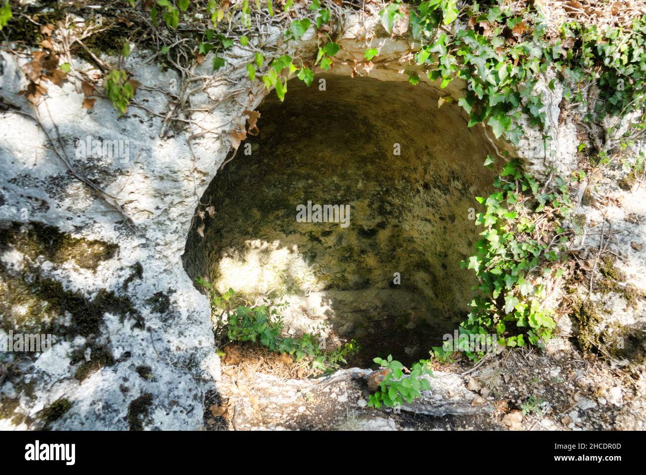Entrance to a man-made cave in a limestone rock. A place of refuge for ...
