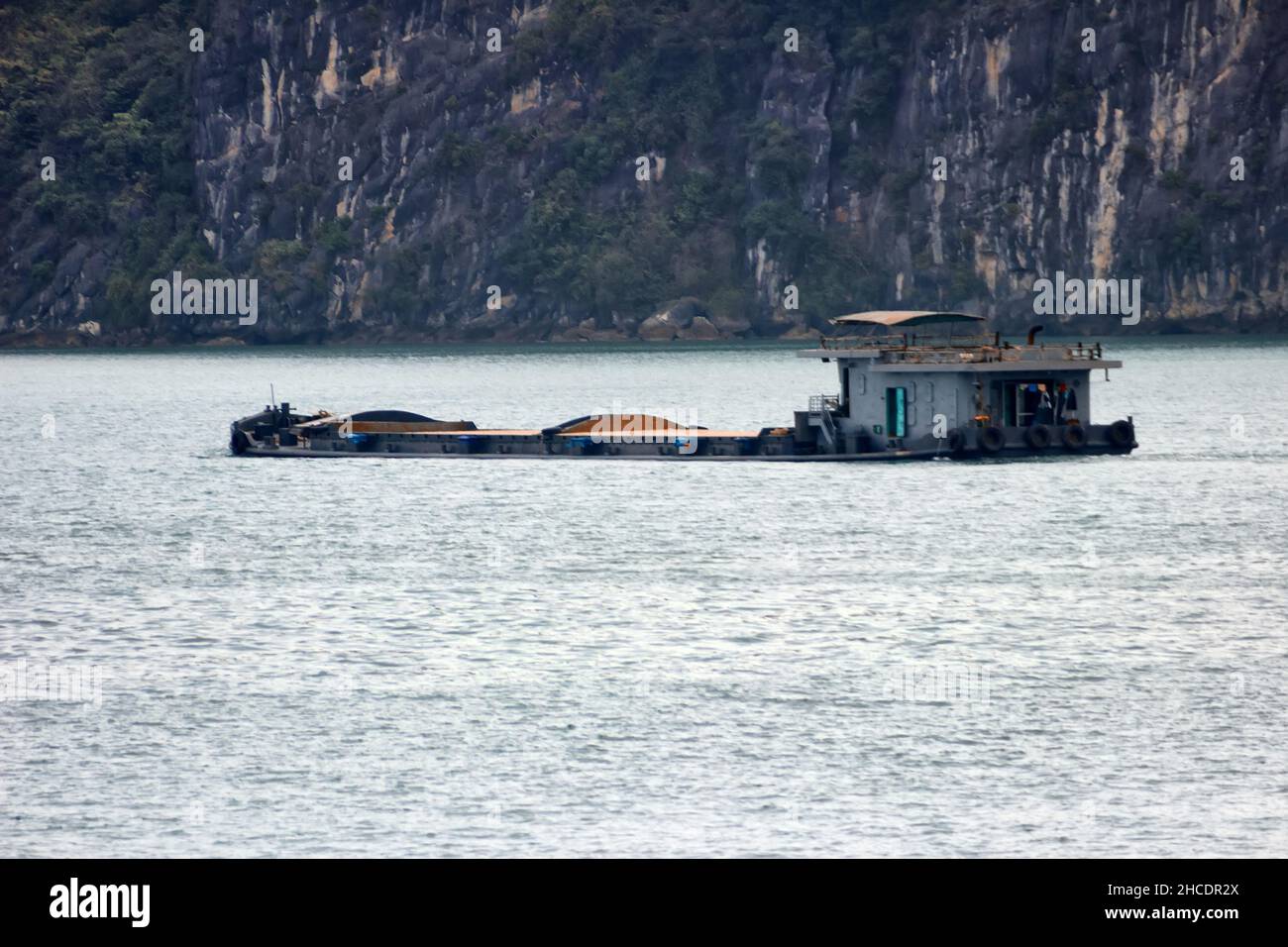 Shipping in Halong Bay, Vietnam. Self-propelled barges (medium landing craft). Against the ...