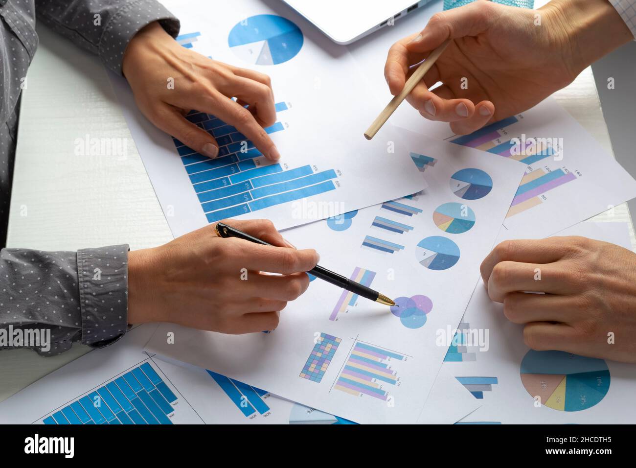 Hands of business people on the desktop. Analysis of financial data ...