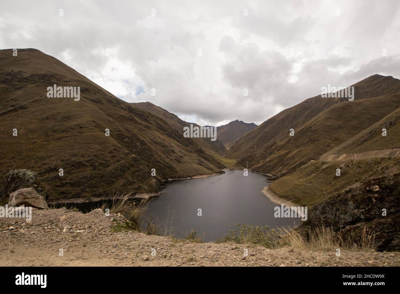 Small dark lake surrounded by mountains and hills in Peru Stock Photo ...