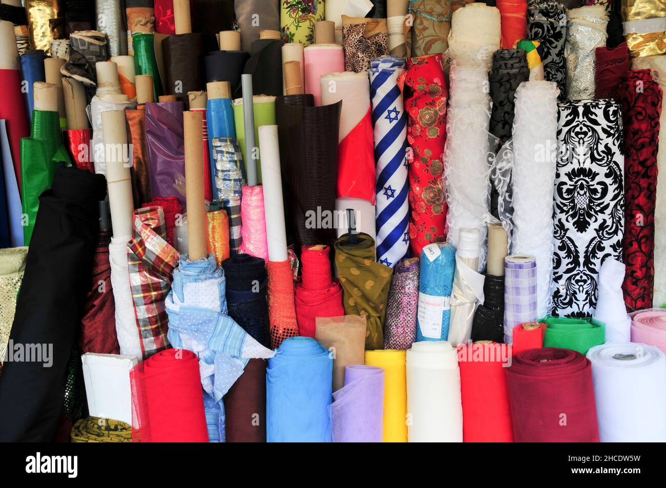 Colourful rolls of fabric on display in a store Stock Photo - Alamy