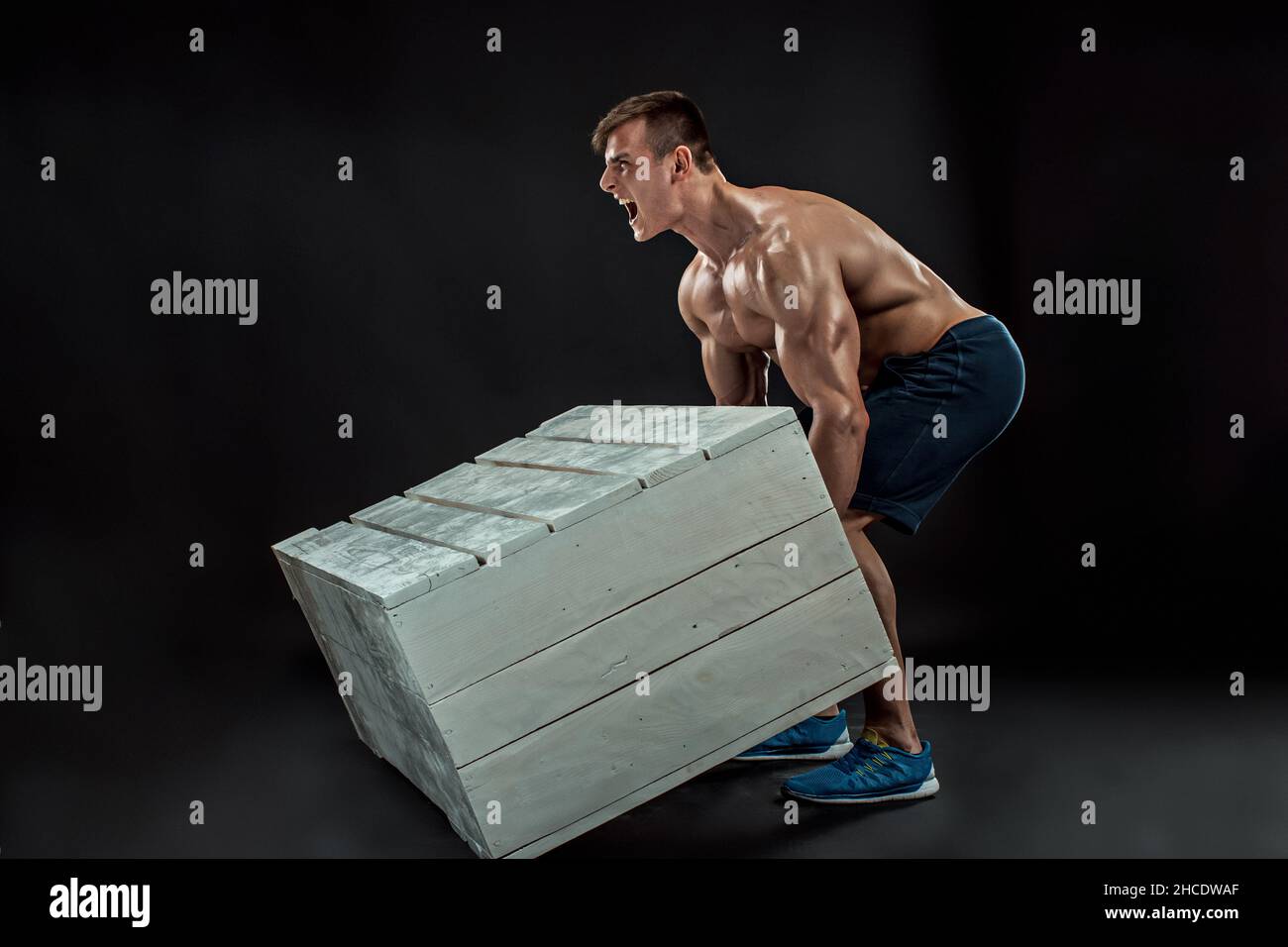 Young Muscular man flipping box Stock Photo - Alamy