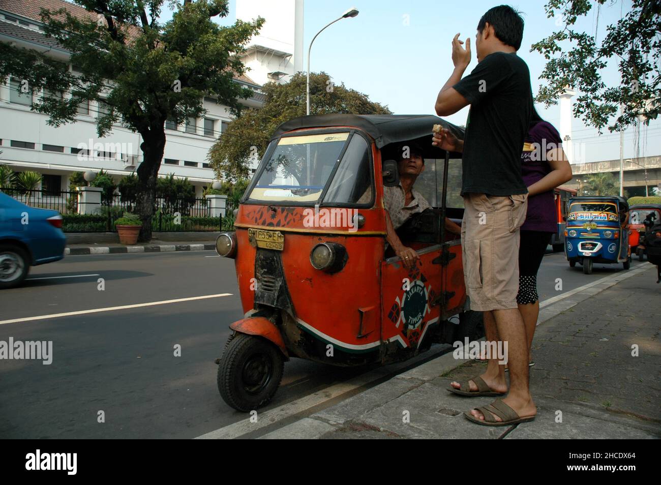 Jakarta, Indonesia - June 29, 2008 : Red Bajaj is waiting for ...