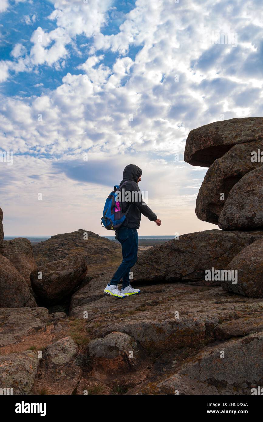 Traveler hiker man with backpack walking climbing mountain summit ...