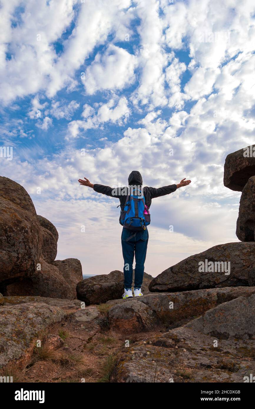 Traveler hiker man with backpack raised hands on mountain summit ...