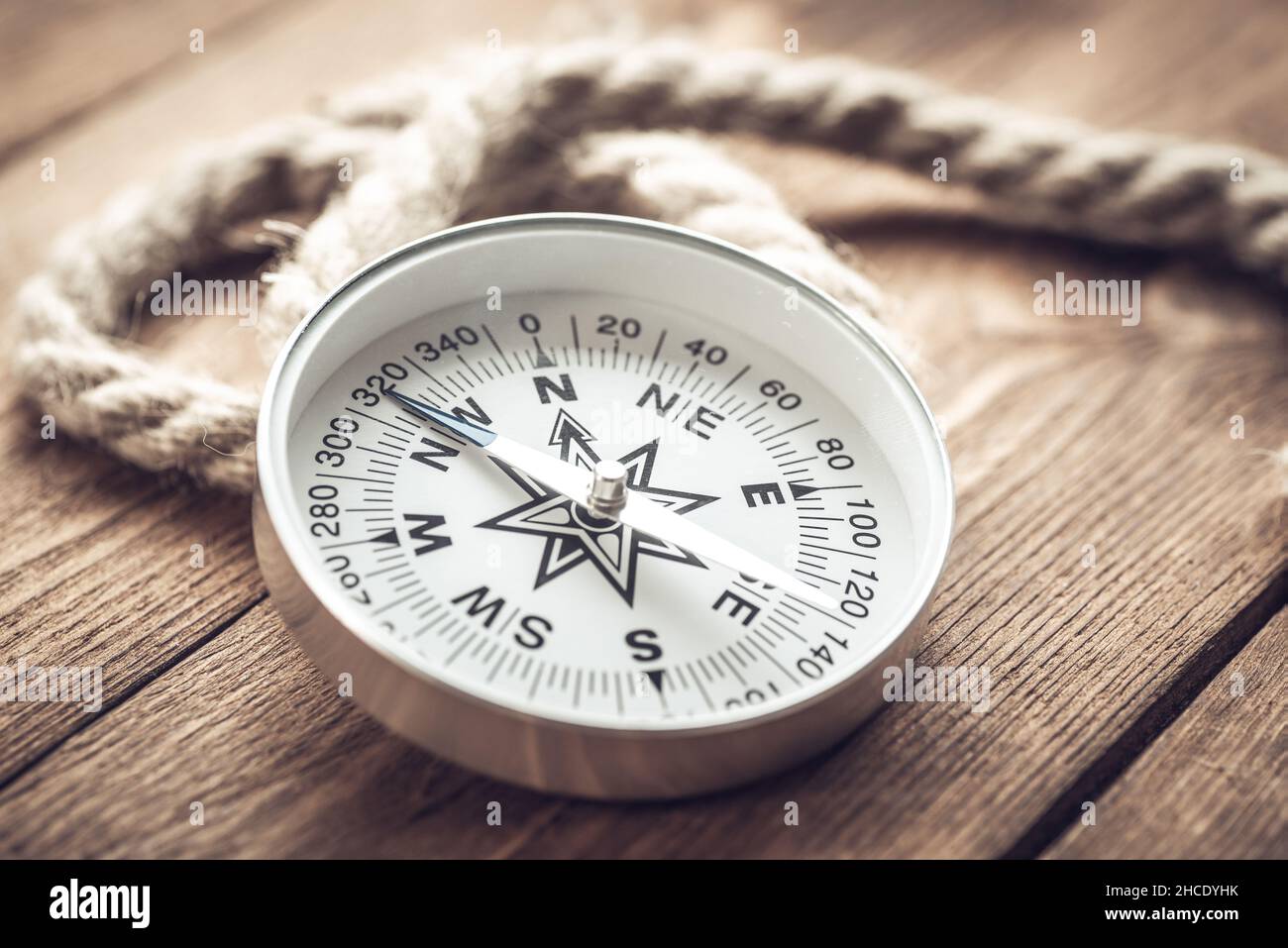 Compass and rope on wooden texture background Stock Photo - Alamy