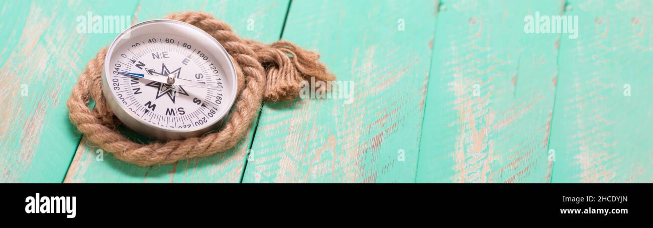 Compass and rope on wooden texture background Stock Photo - Alamy