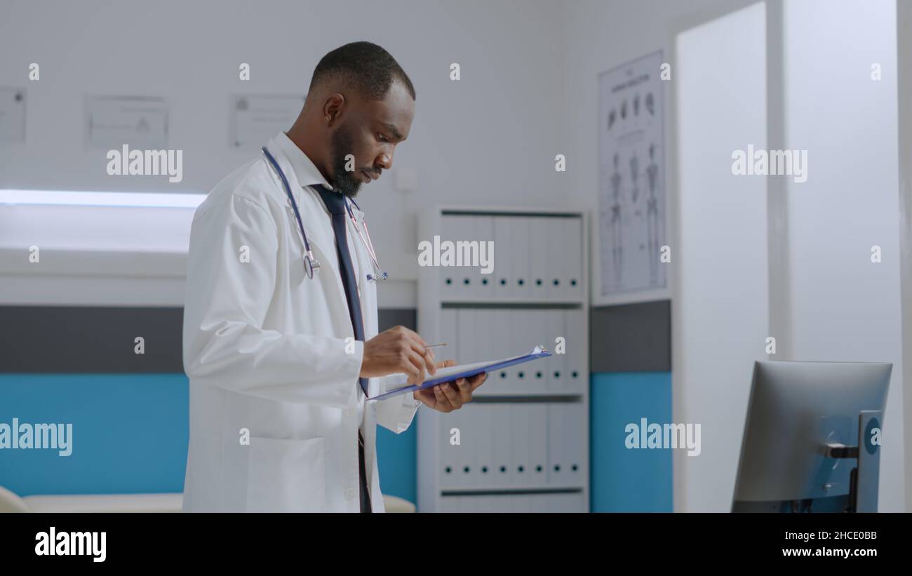 African american specialist doctor checking sickness report documents ...