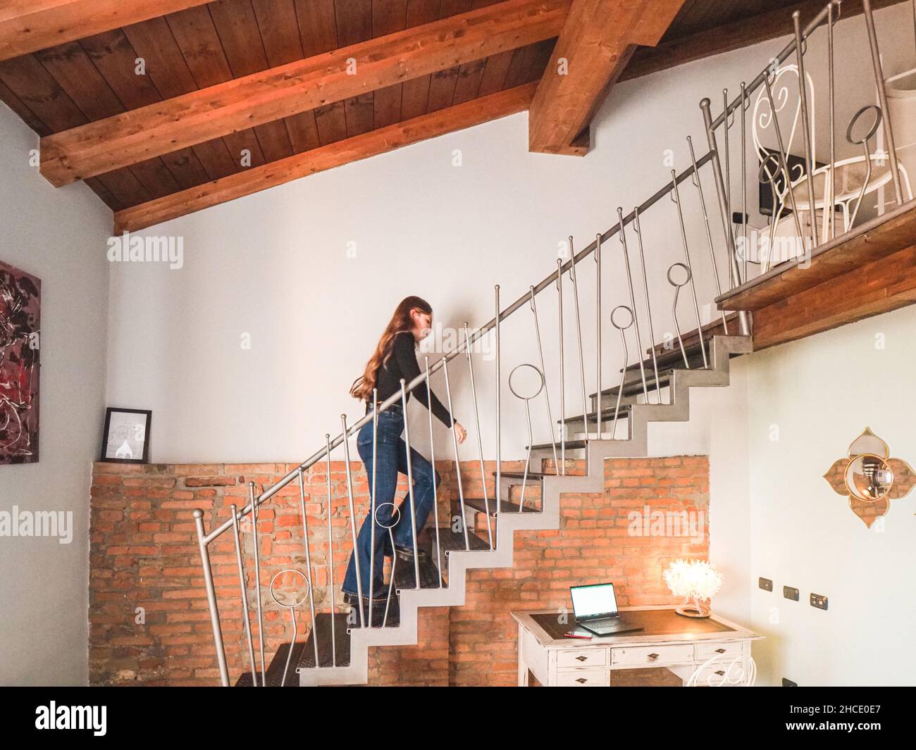 Young beautiful stylish Caucasian female climbing the stairs in her ...