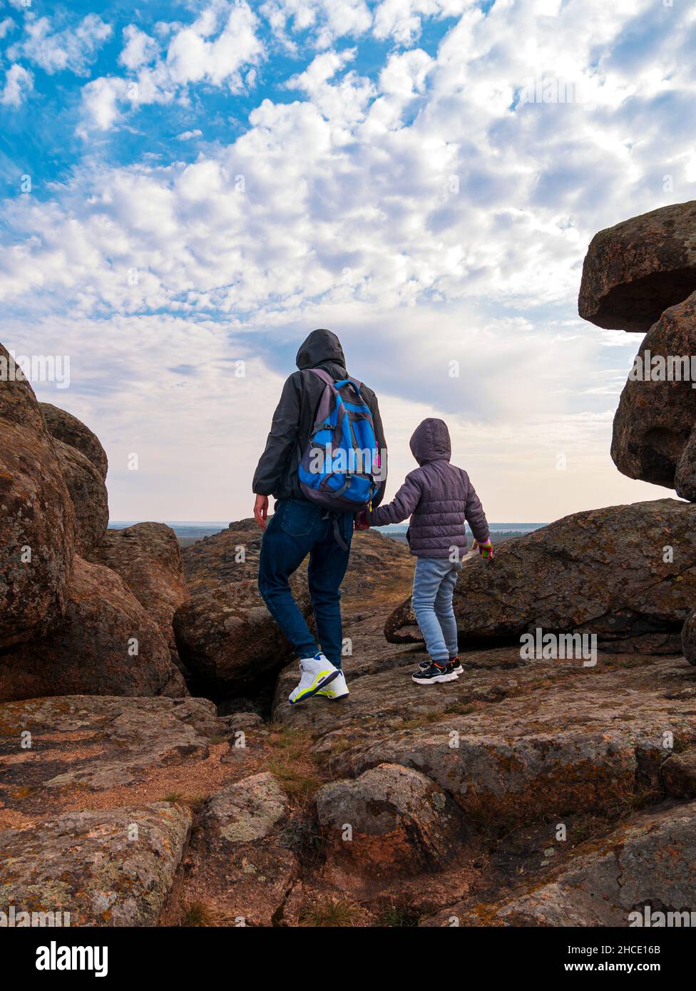 Travelers father and daughter walking climbing on mountain summit ...