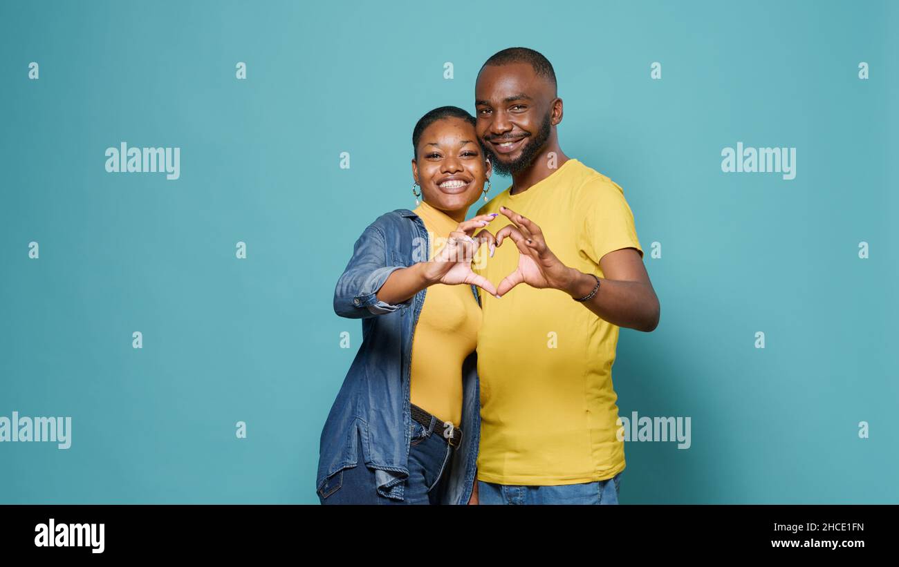 People in love advertising heart shape sign with hands in front of ...