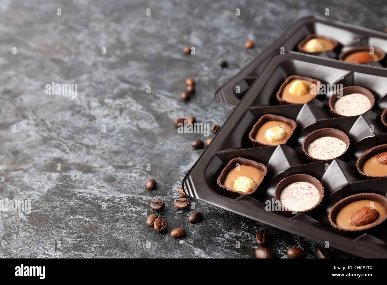 Concept of sweets with chocolate candies on dark textured background ...