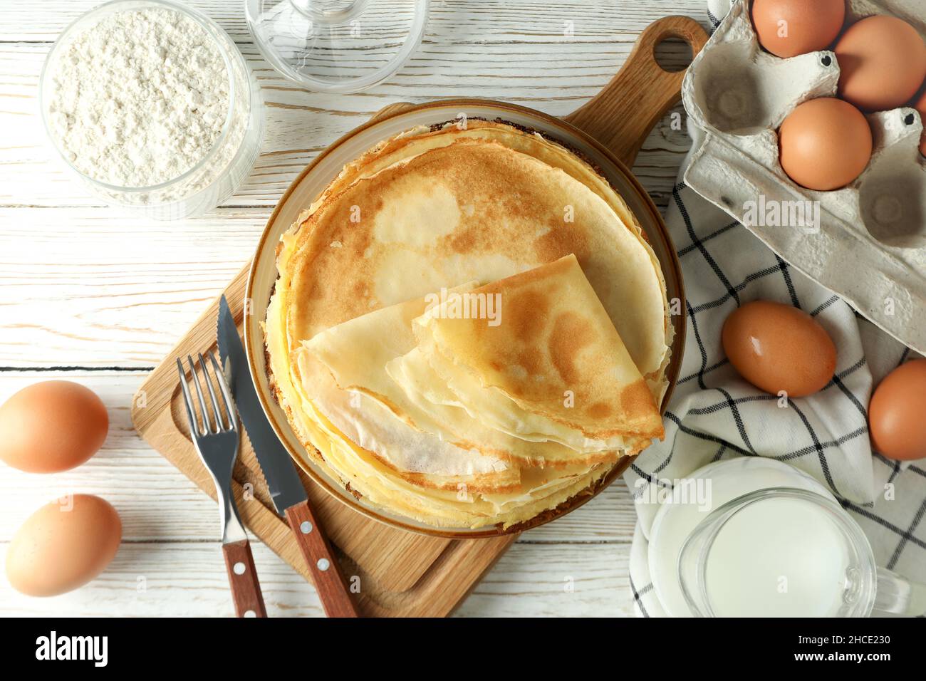 Concept of cooking crepes on white wooden table Stock Photo - Alamy