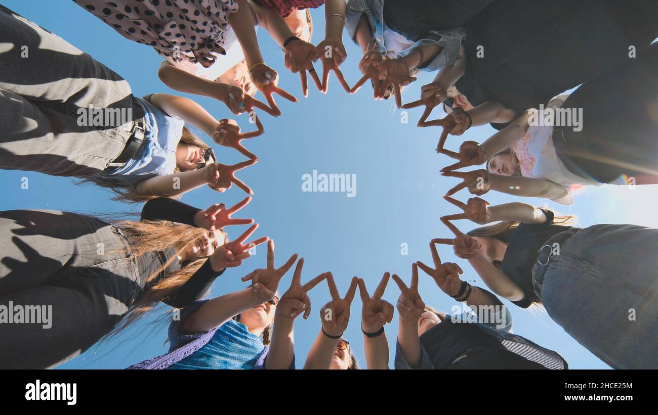 A group of girls makes a circle from their fingers Stock Photo - Alamy