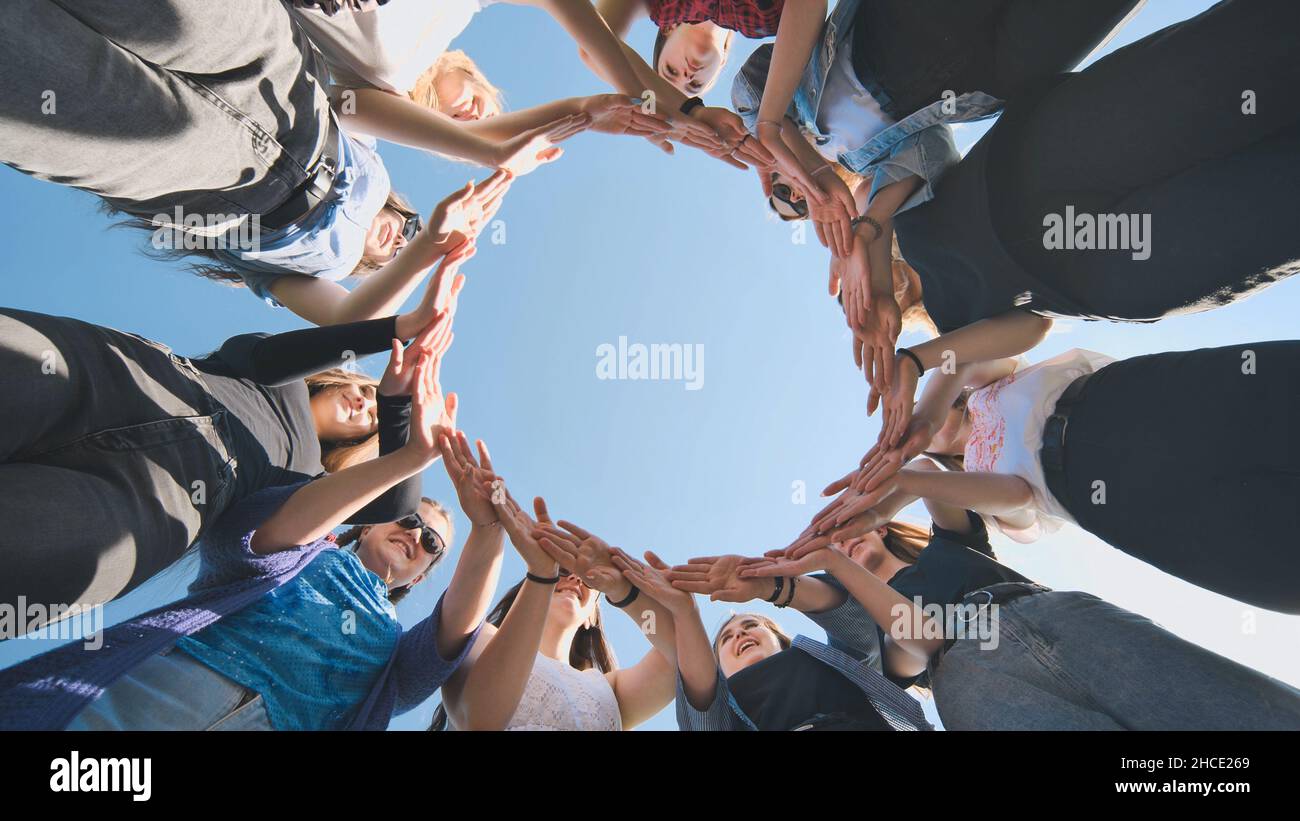 A group of girls makes a circle from their palms Stock Photo - Alamy