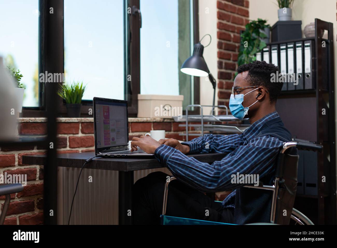 African american employee who is paralyzed wearing covid19 protection ...