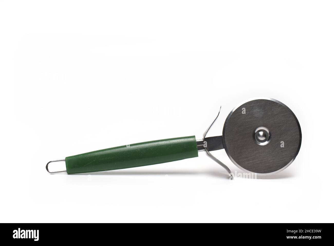 Close up of pizza cutter for rolling with cutting wheel and green ...