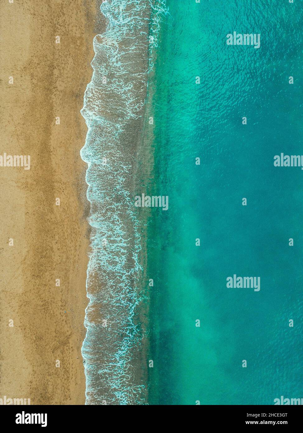 Vertical top view of green sea waves on a sandy shore Stock Photo - Alamy