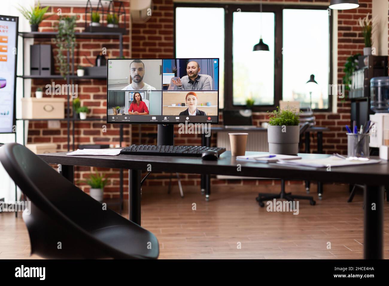 Computer with video call conference on desk in empty office. Online ...