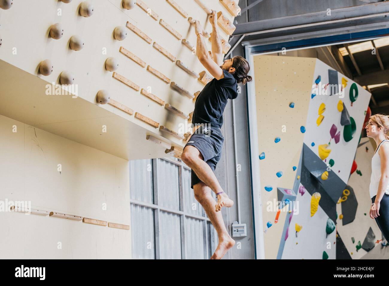 Full body side view of sportive barefoot male in activewear practicing ...