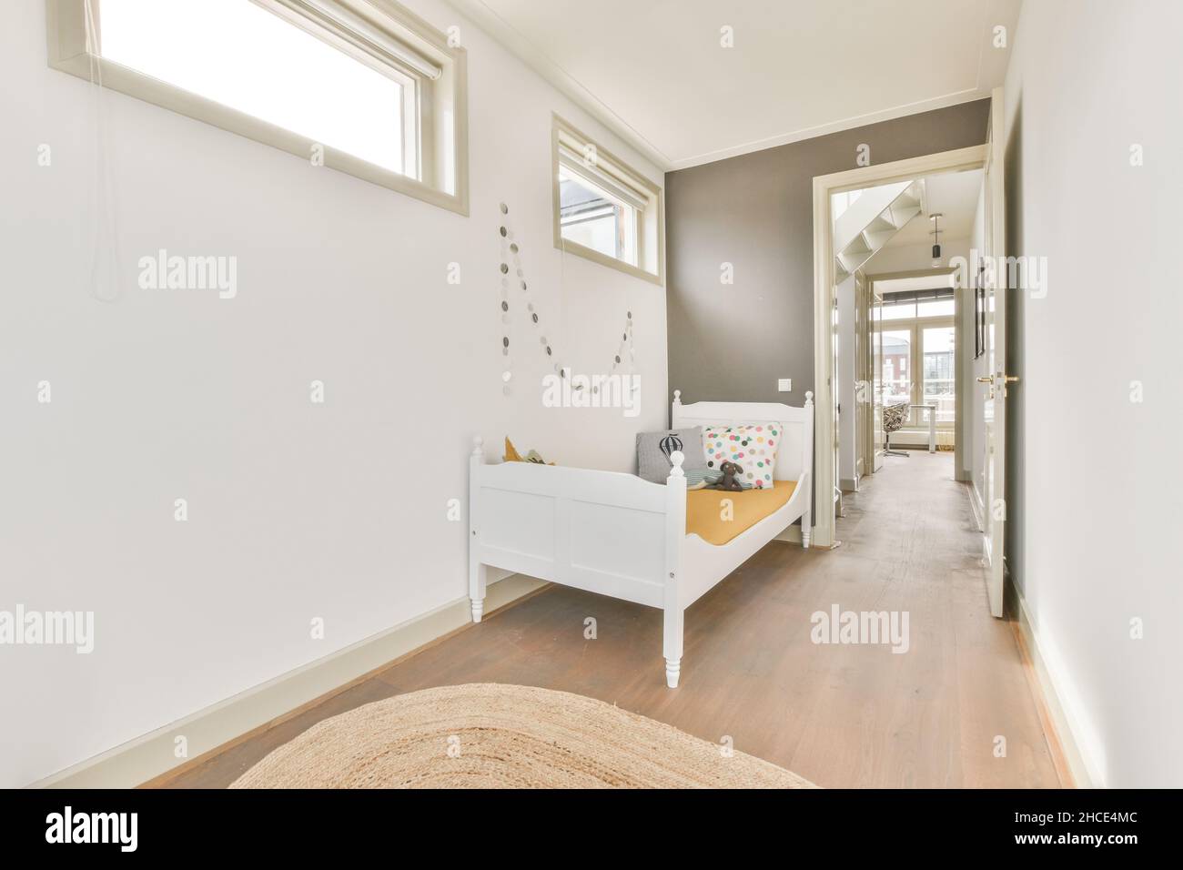 Light narrow children bedroom furnished with single bed placed on ...