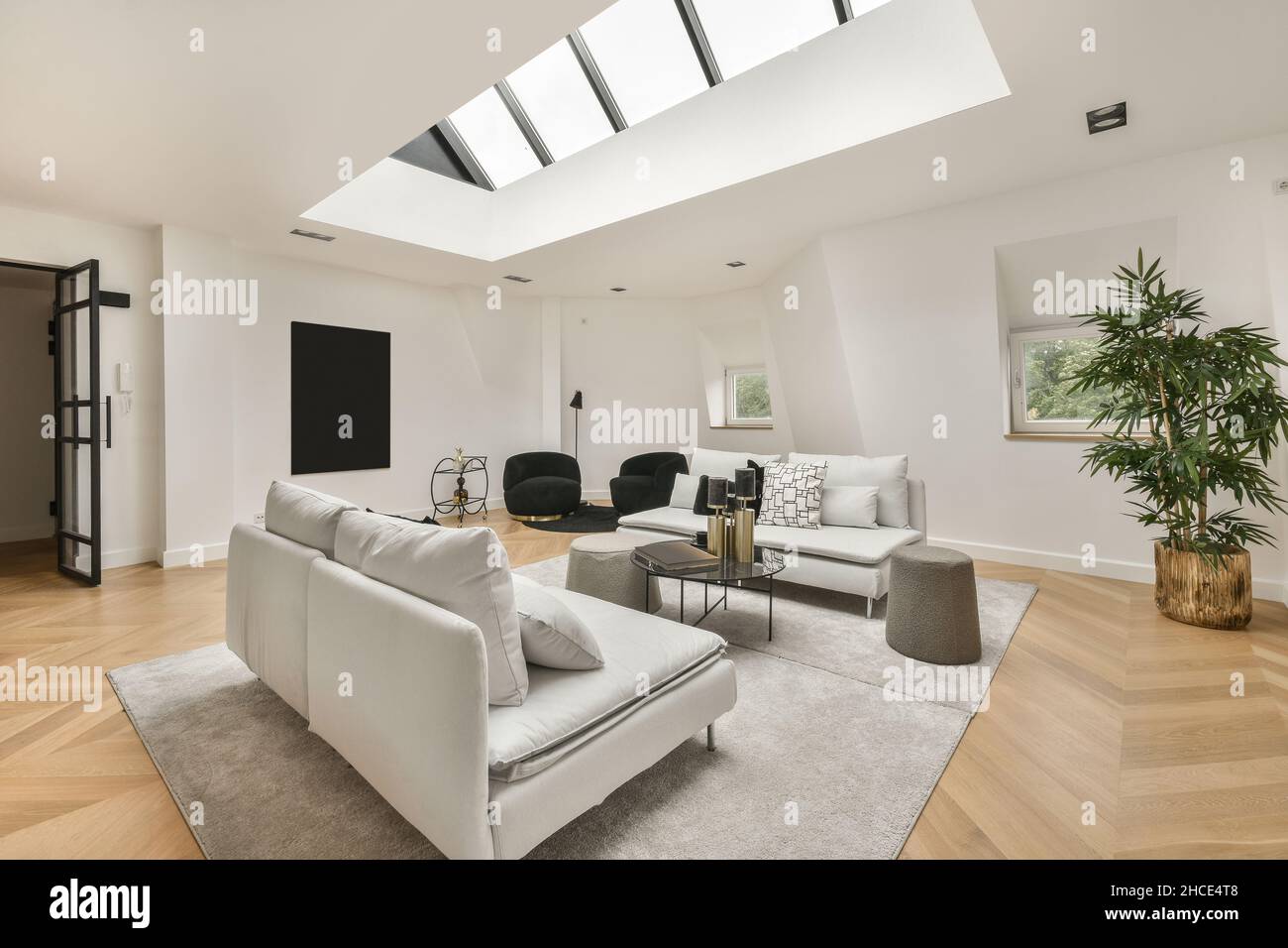 Interior of spacious living room furnished with comfortable white ...