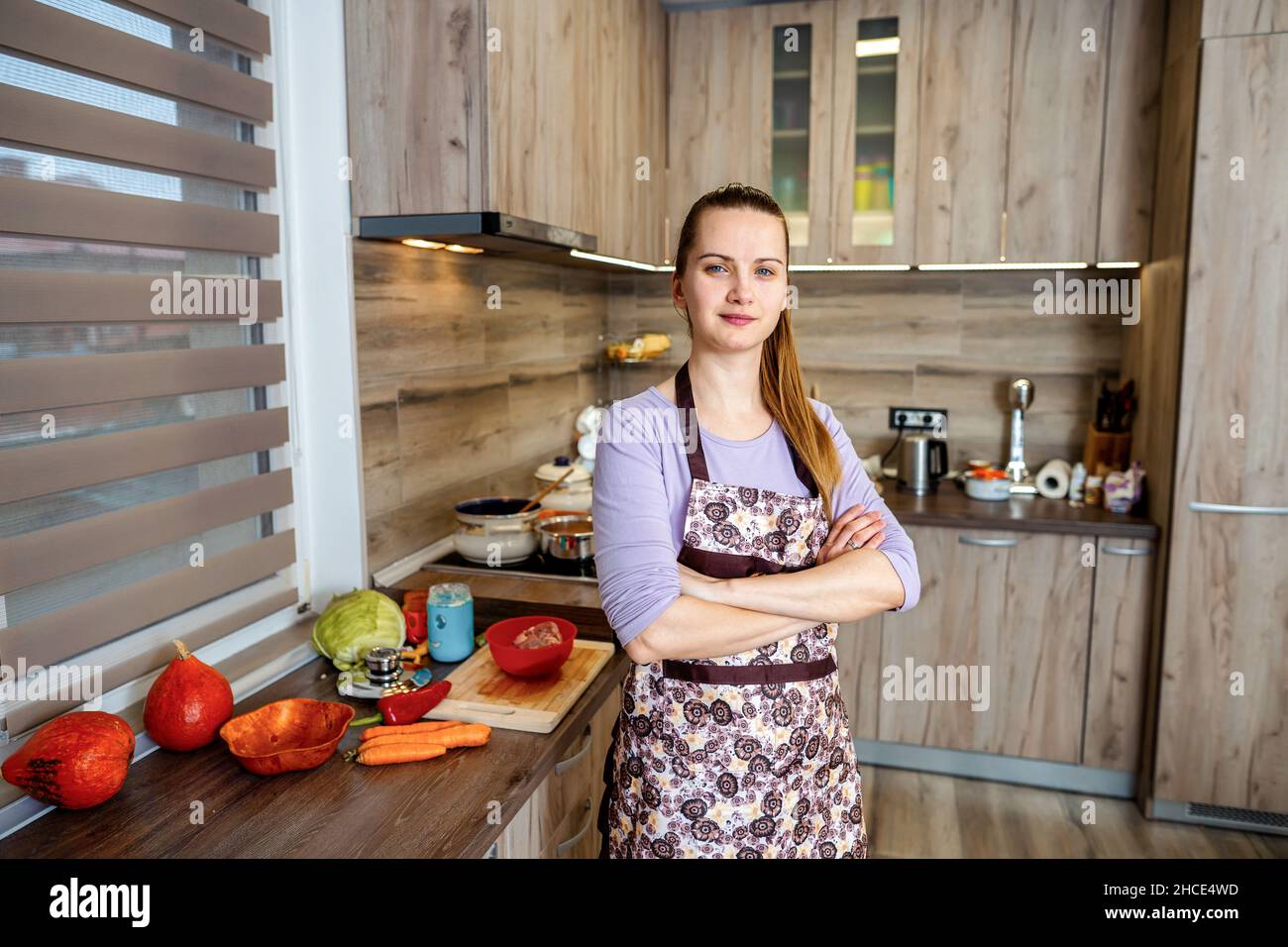 Caucasian female making food in a kitchen Stock Photo - Alamy