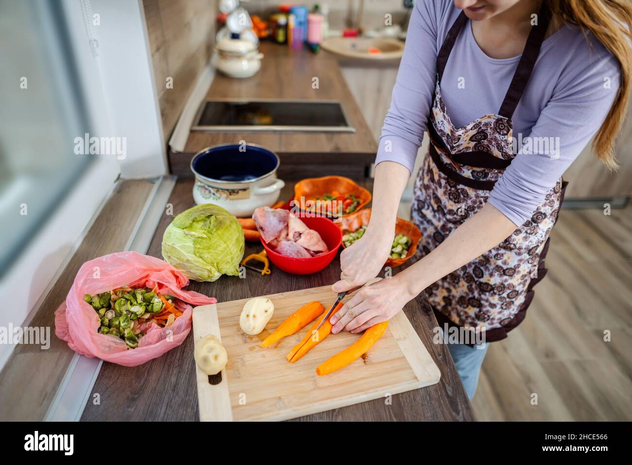 Caucasian female making food in a kitchen Stock Photo - Alamy