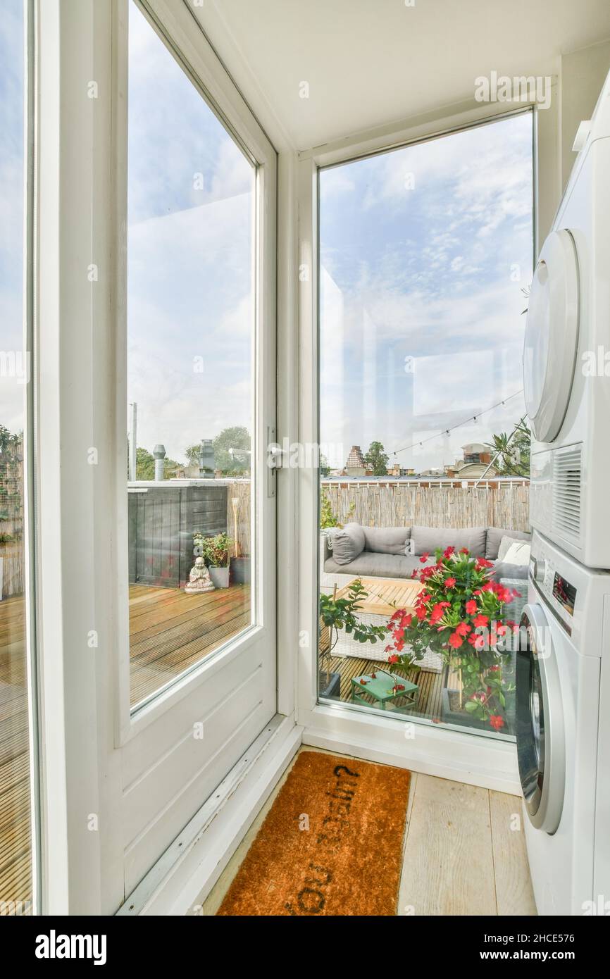 Modern washing and drying machines in laundry room with glass doors ...