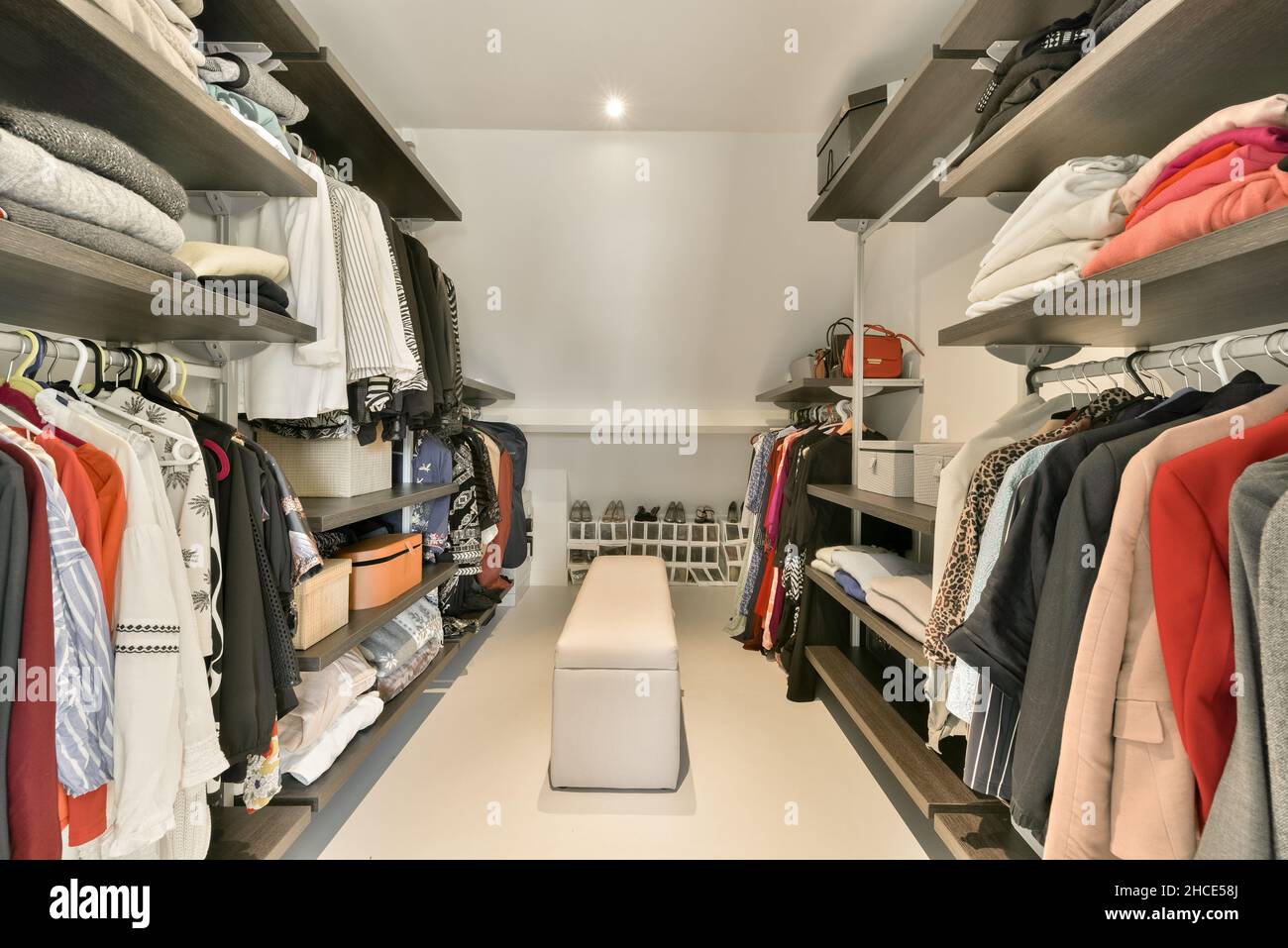 Interior of spacious closet in minimal style with various apparel on ...