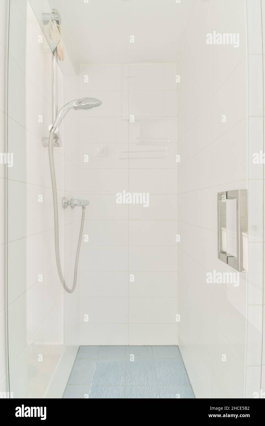 Light empty shower cabin with metal set in modern bathroom with white ...
