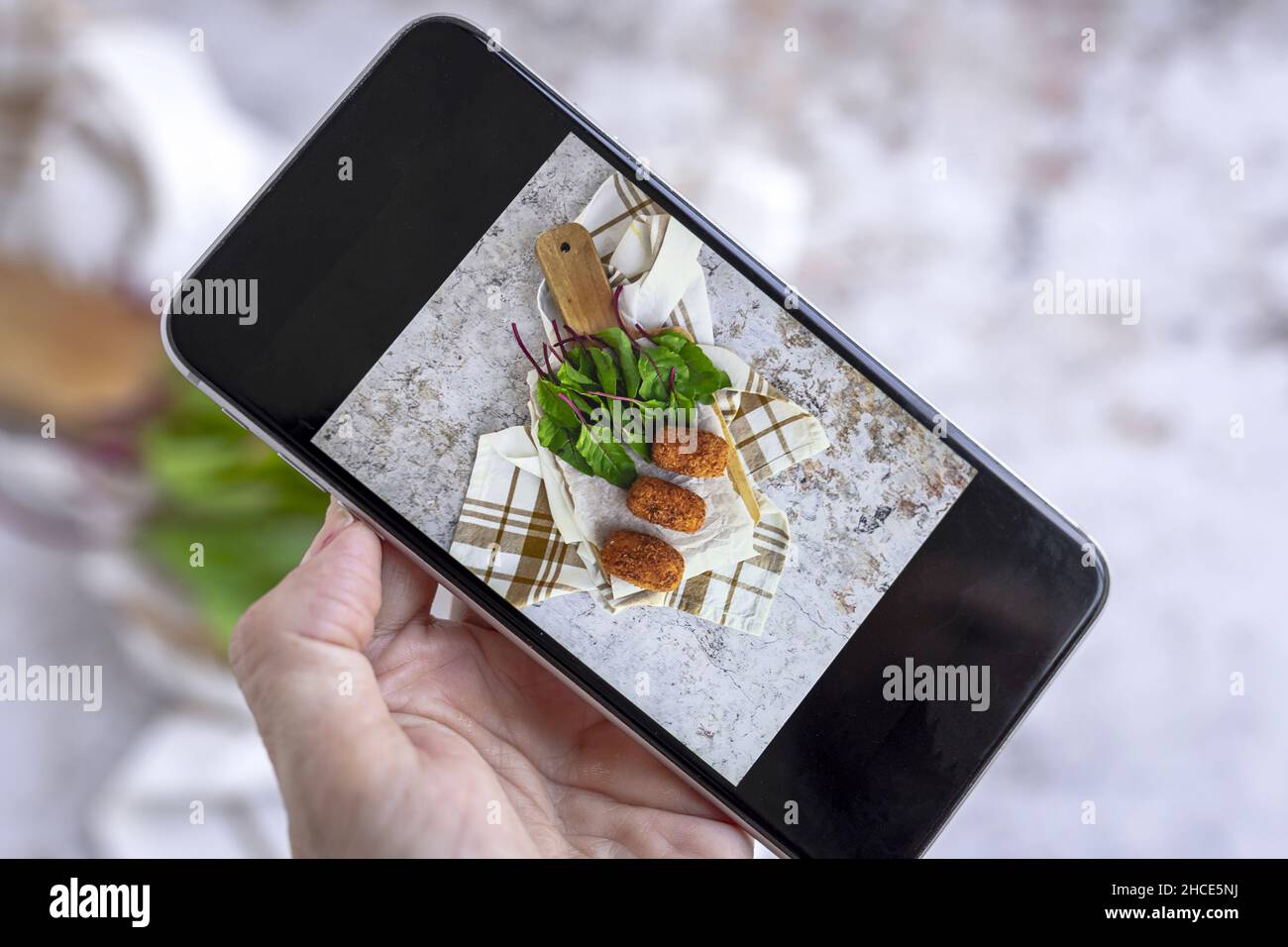 Top view of crop anonymous person showing smartphone with photo of deep ...