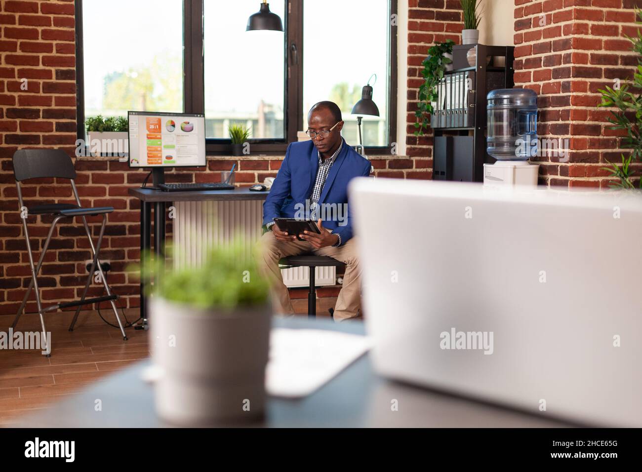 Employee using digital tablet to work on marketing strategy at ...