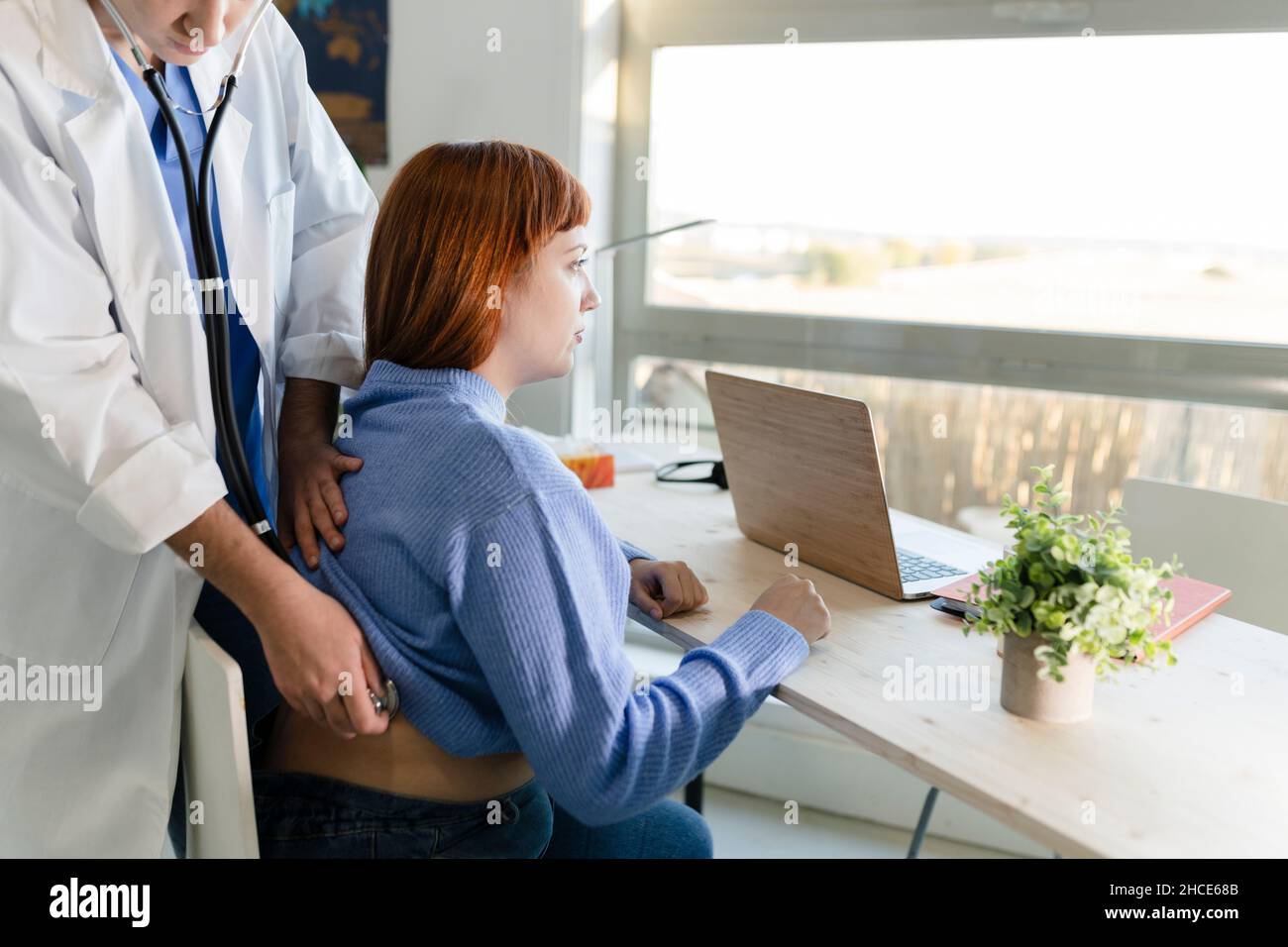 Crop unrecognizable medic in uniform examining breath of faceless sick ...
