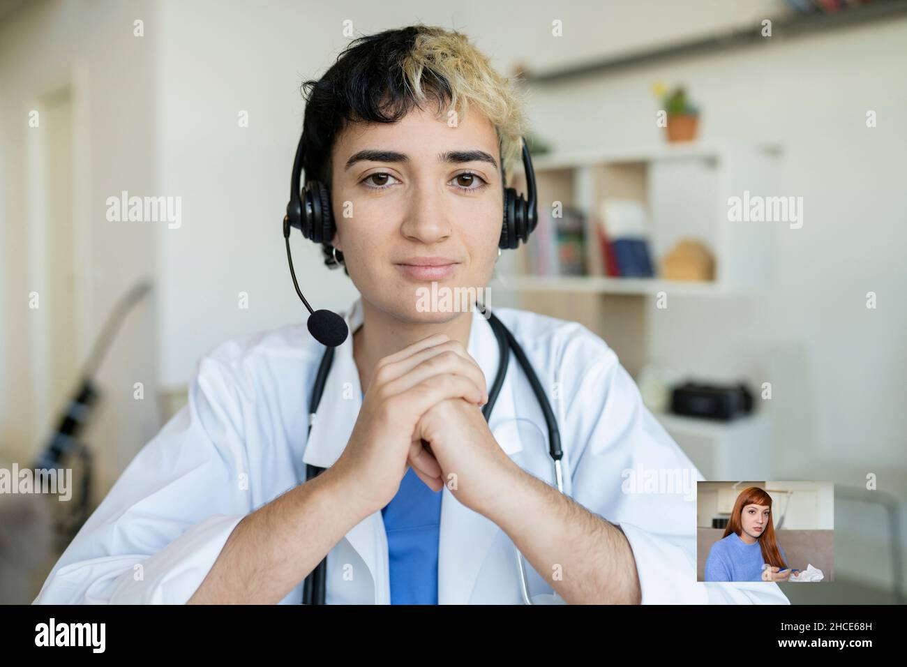 Professional female medical operator with headset in uniform looking at ...