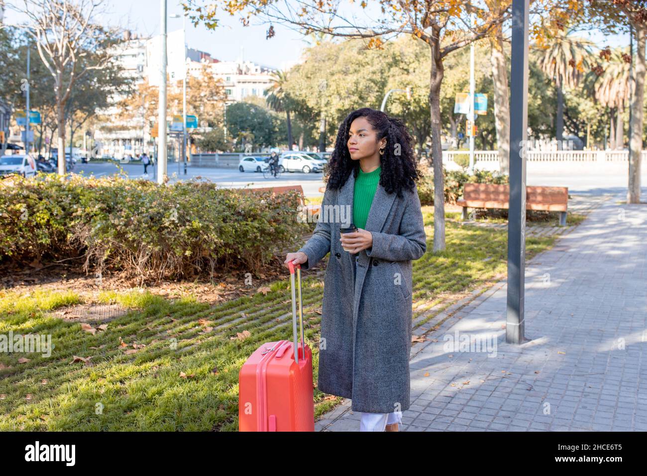 Full body of cheerful friends raising bottles of beer while laughing ...