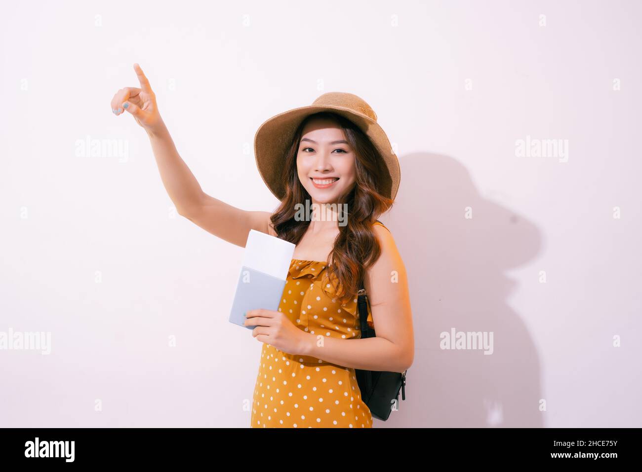 Travel concept portrait of smiling woman holding passport with ticket ...