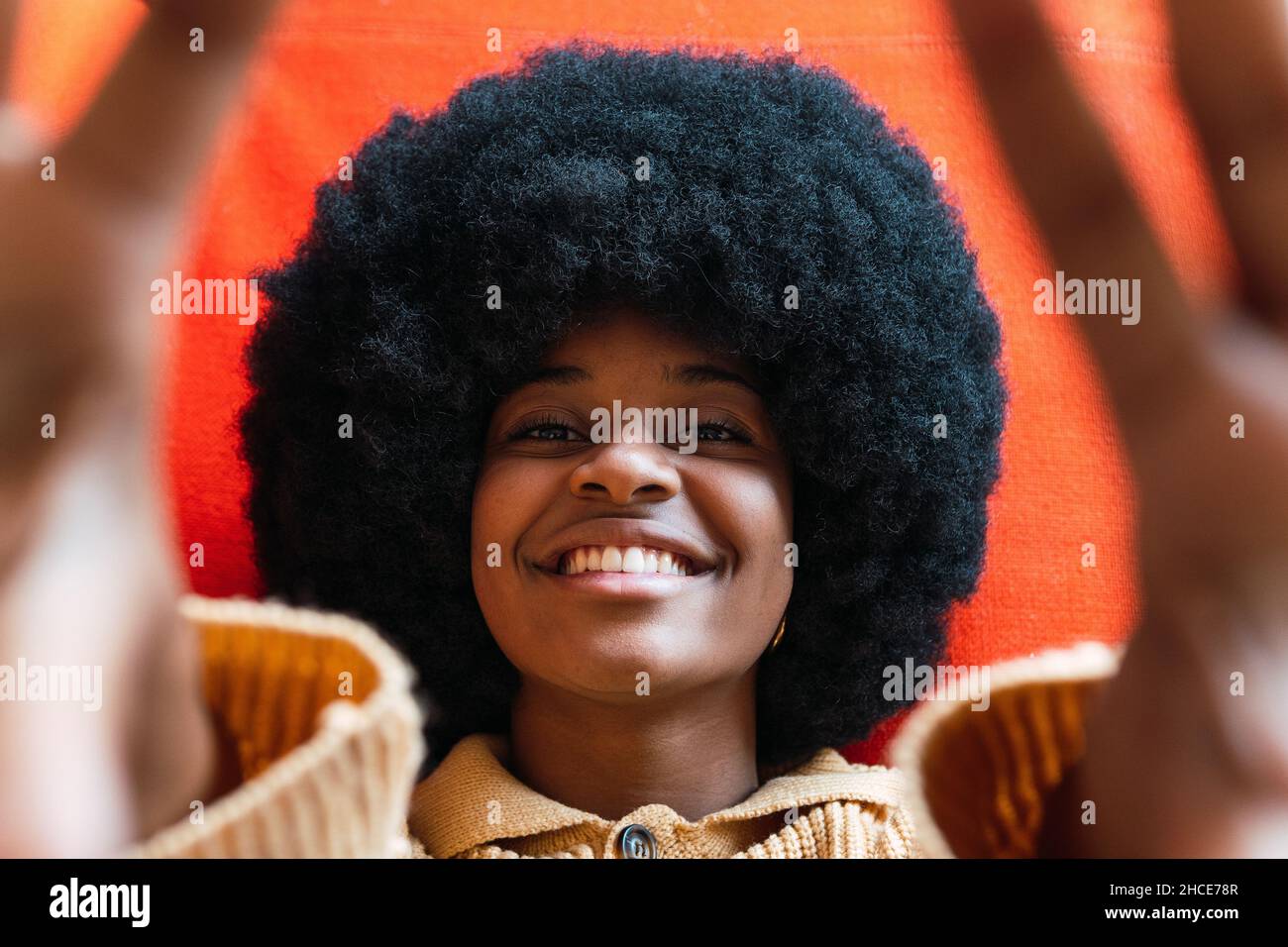 From above portrait of cheerful young African American female with Afro ...