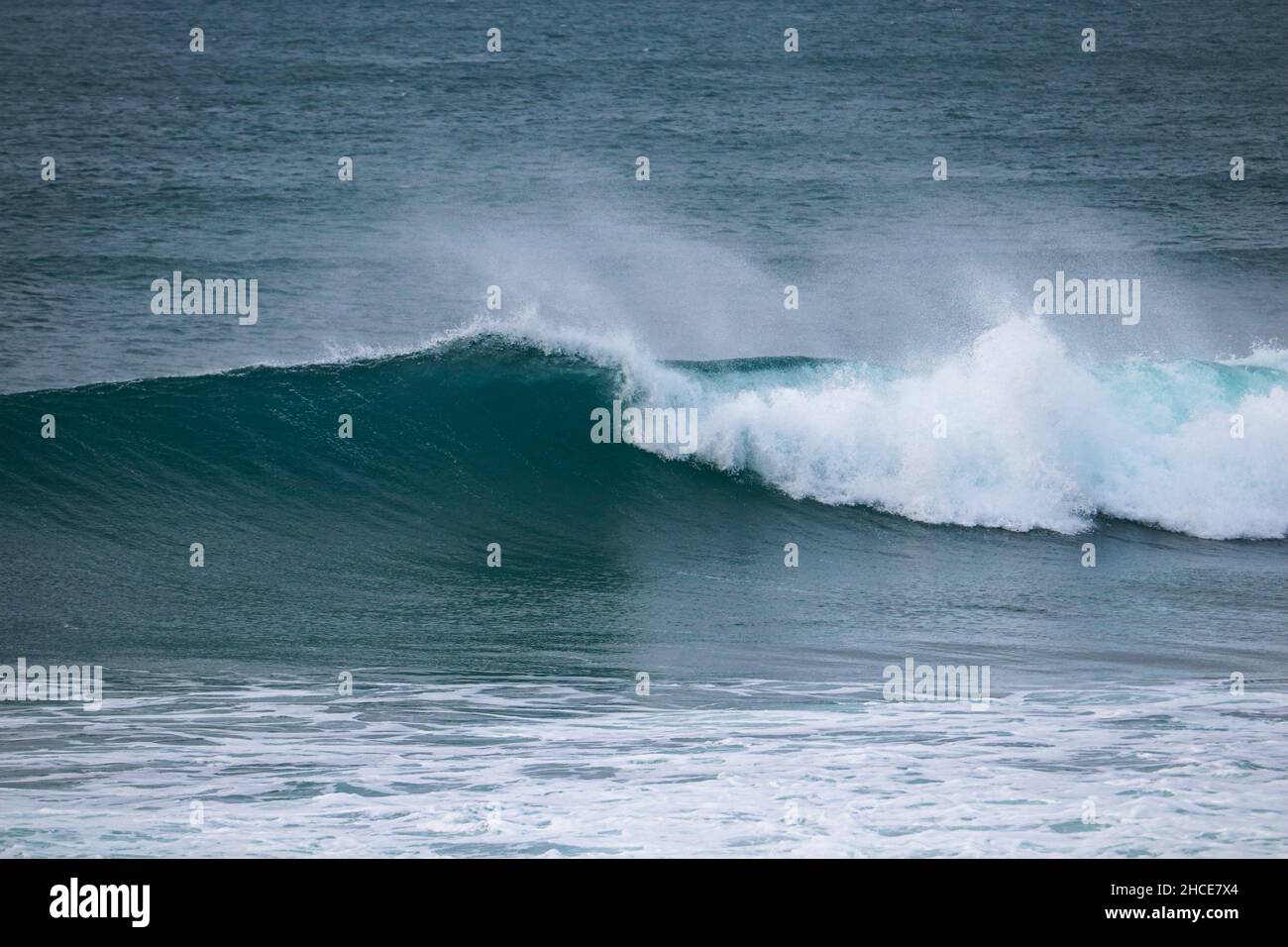 Perfect wave breaking in a beach. Surf spot Stock Photo - Alamy