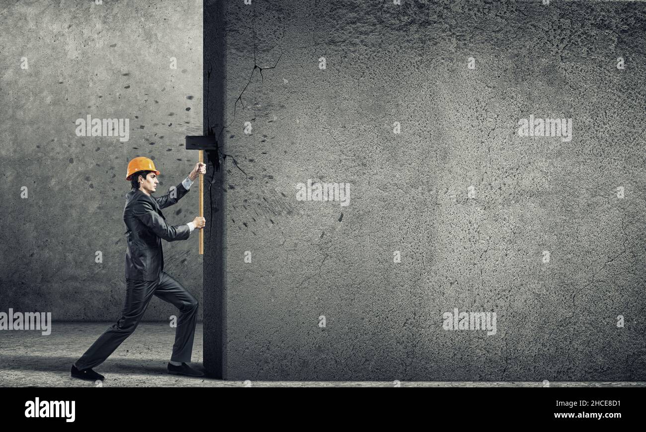 Engineer man break wall Stock Photo - Alamy